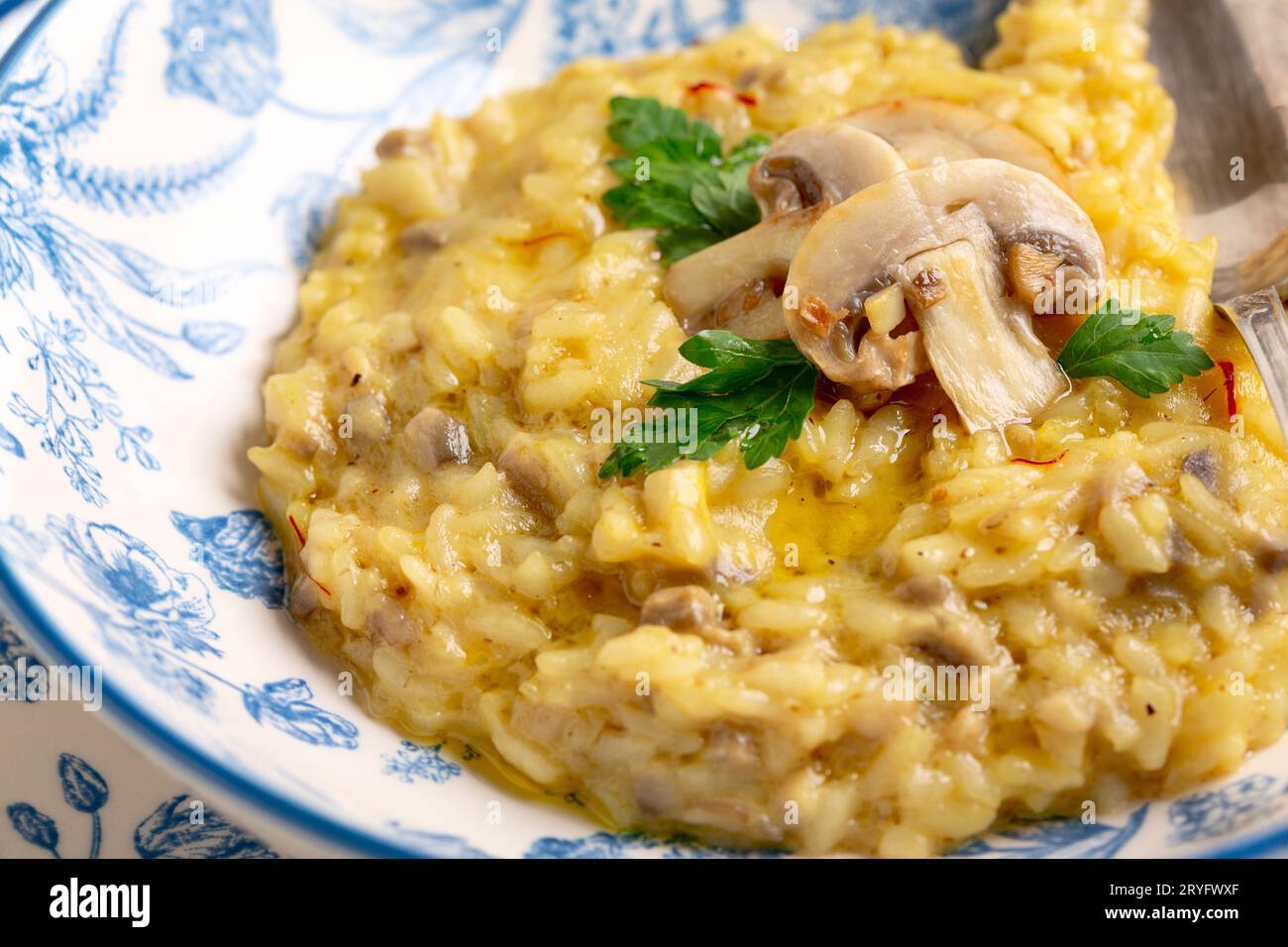 Risotto with mushrooms and saffron Stock Photo - Alamy