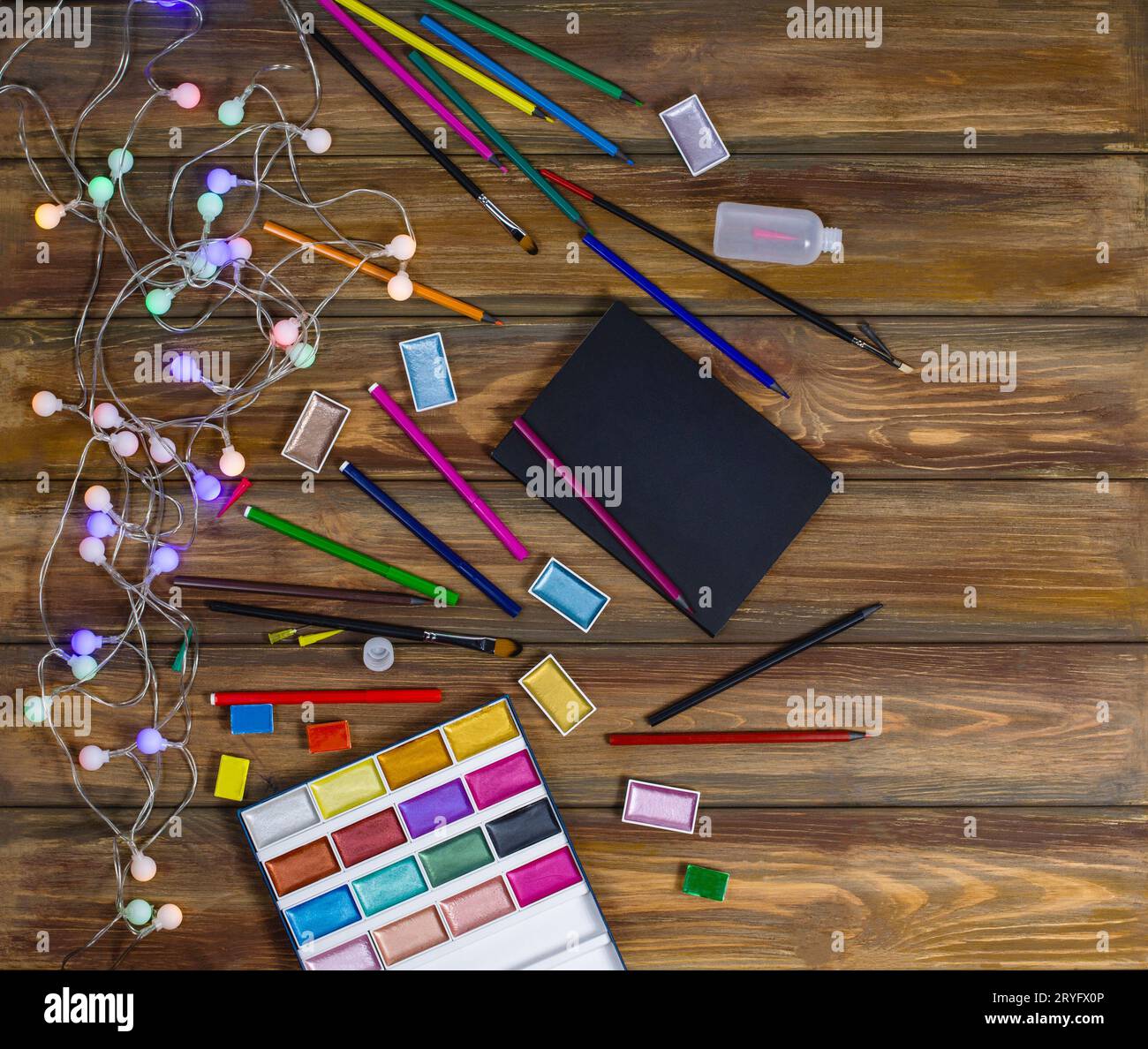 Paint and drawing materials. Drawing tools in an art workshop top view ...