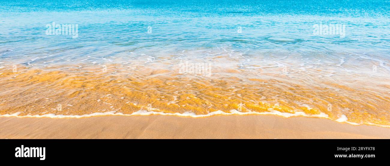Blue sea water and sand beach Stock Photo - Alamy