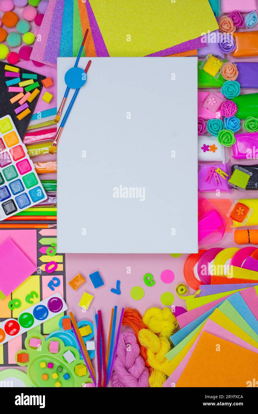 Overhead shot of feminine artist workspace with mock up and painting ...