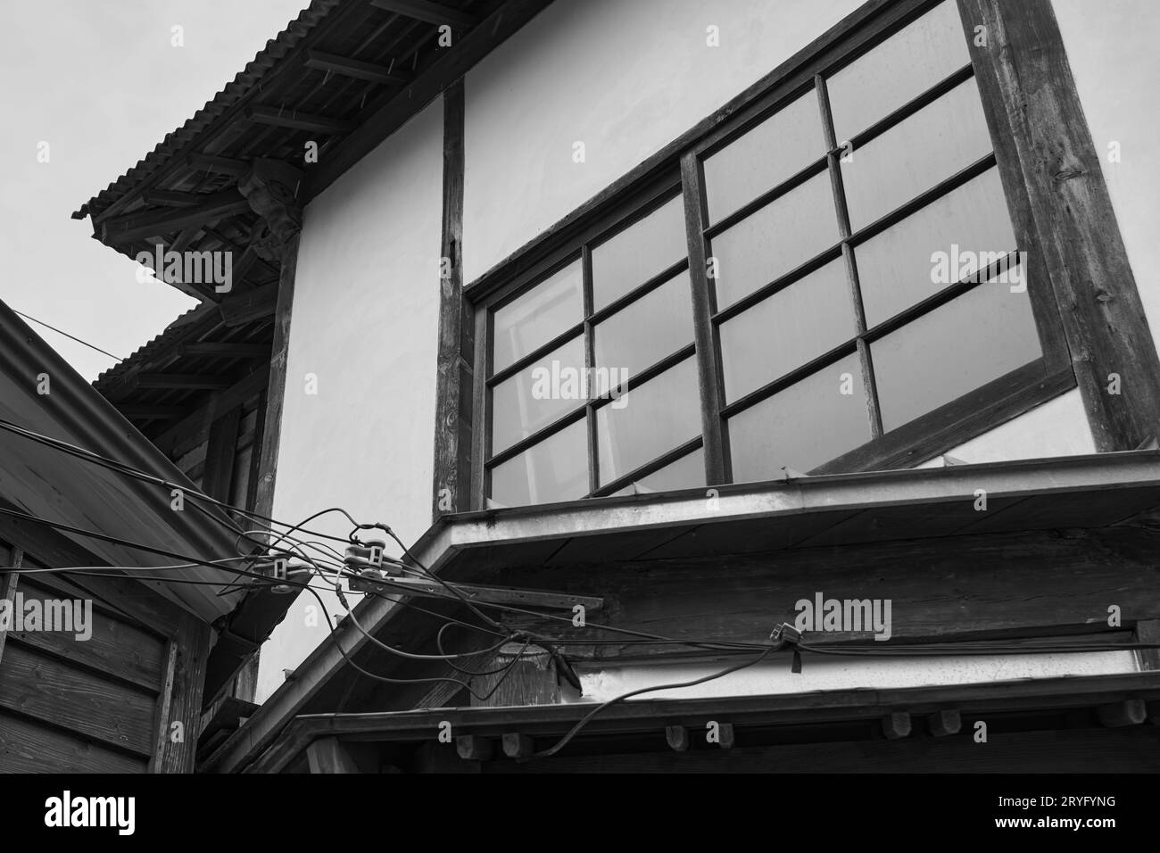 The roof, windows, and power lines of an old Japanese-style building ...
