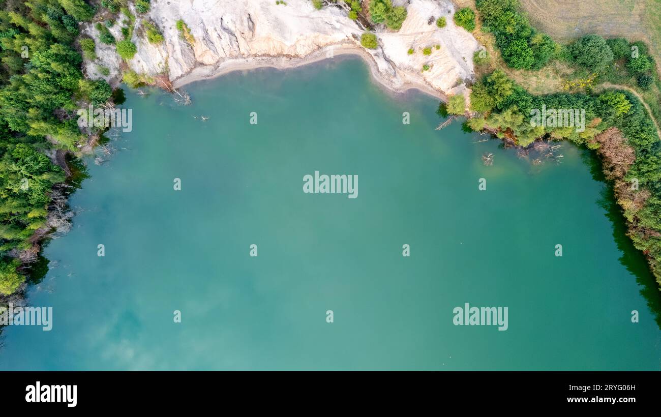 Blue lakes from above. Lakes in green forest in evening sunlight aerial ...