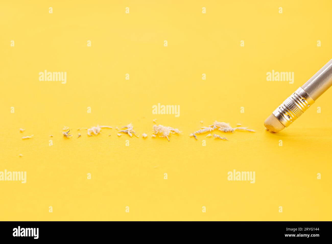 Pencil eraser working on yellow paper background. Mistake, erasing or ...