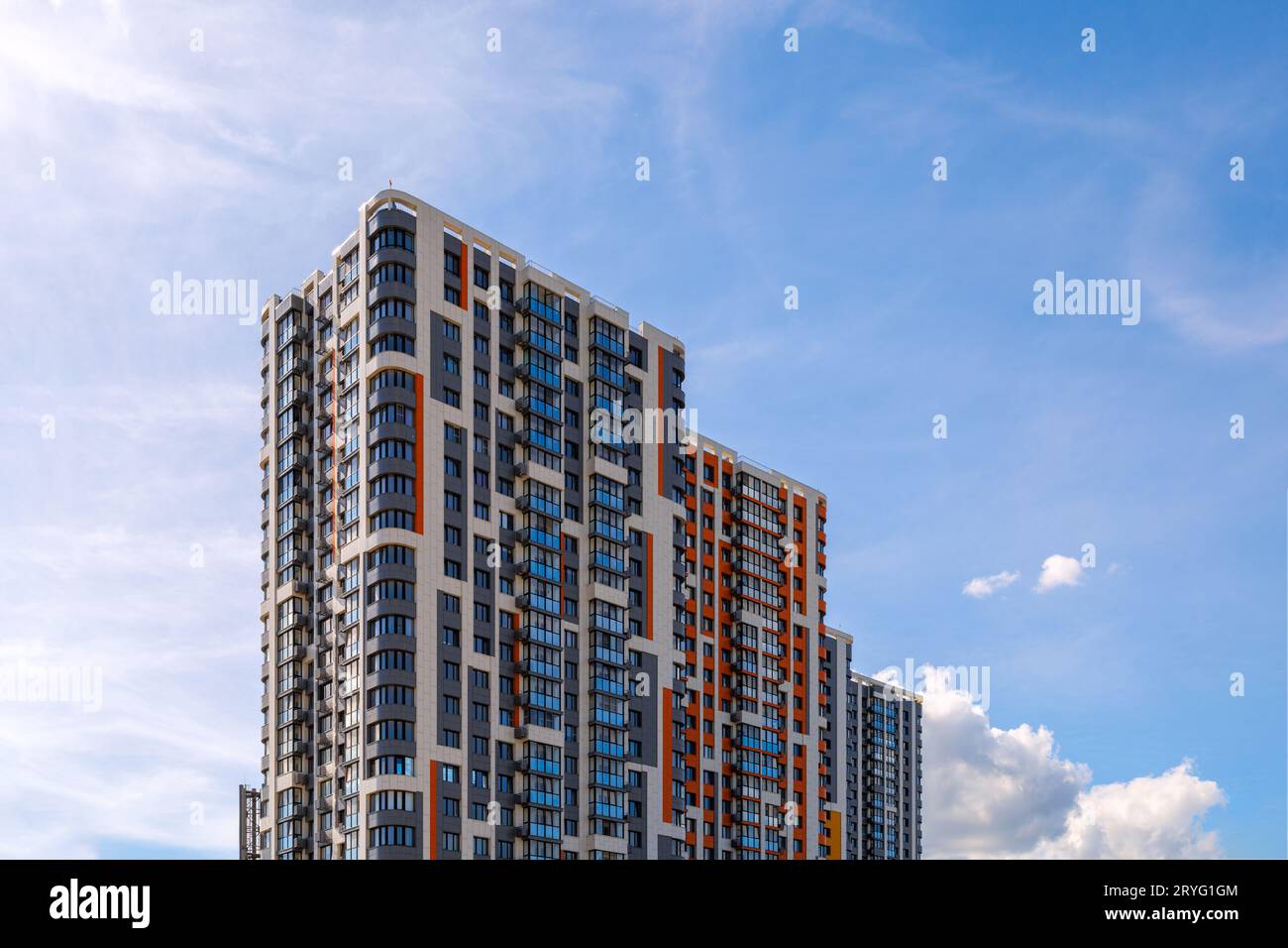 Freshly built high rise apartment building on blue sky background with ...