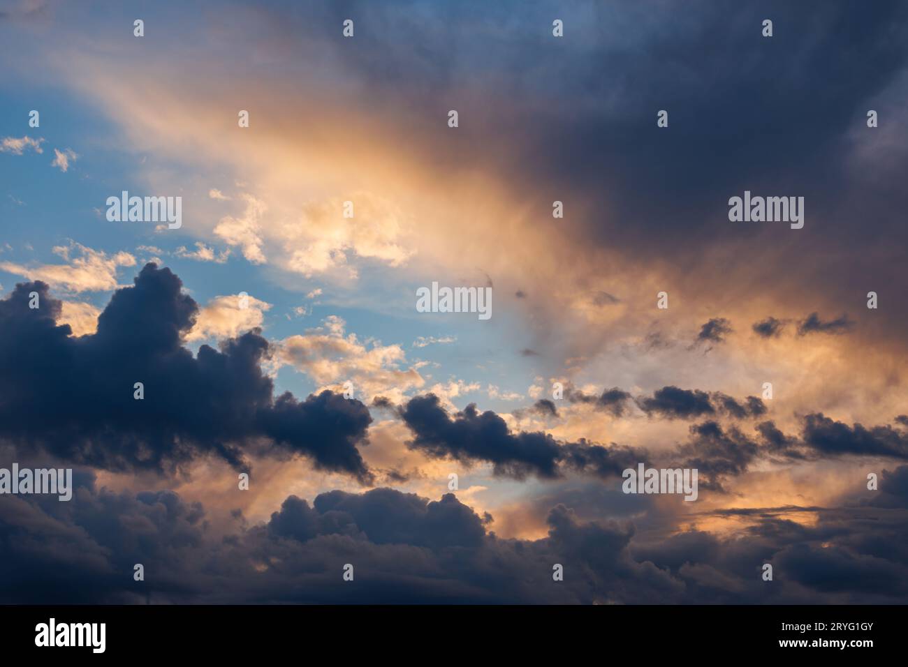 Cumulus clouds on evening sky backlit with sunset Stock Photo - Alamy