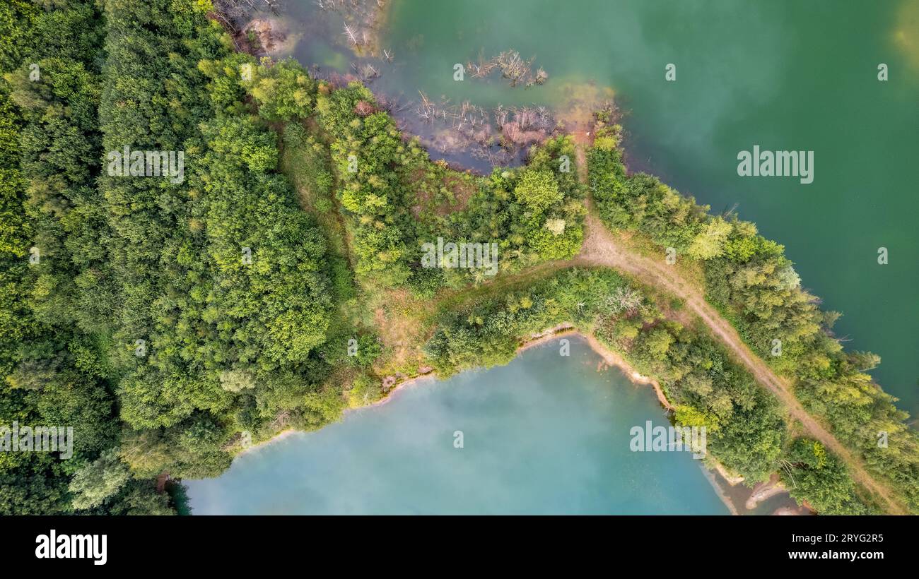 Blue lakes from above. Lakes in green forest in evening sunlight aerial ...