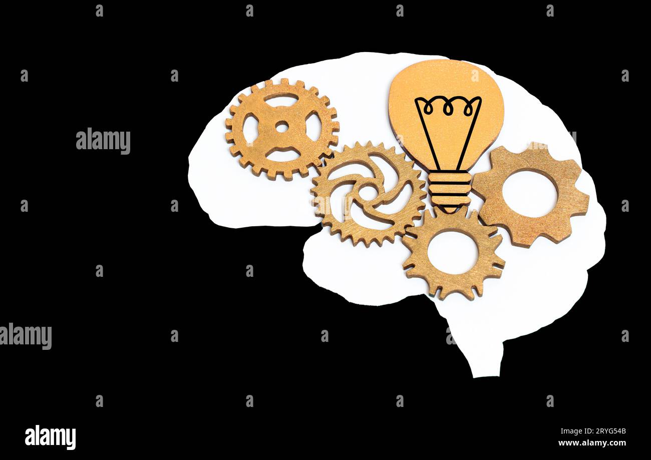 White human brain shape with wooden gears and light bulb inside ...
