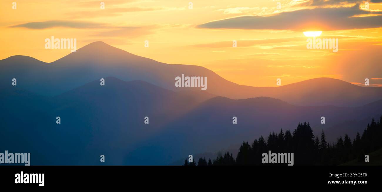 Sunset in mountains Stock Photo - Alamy