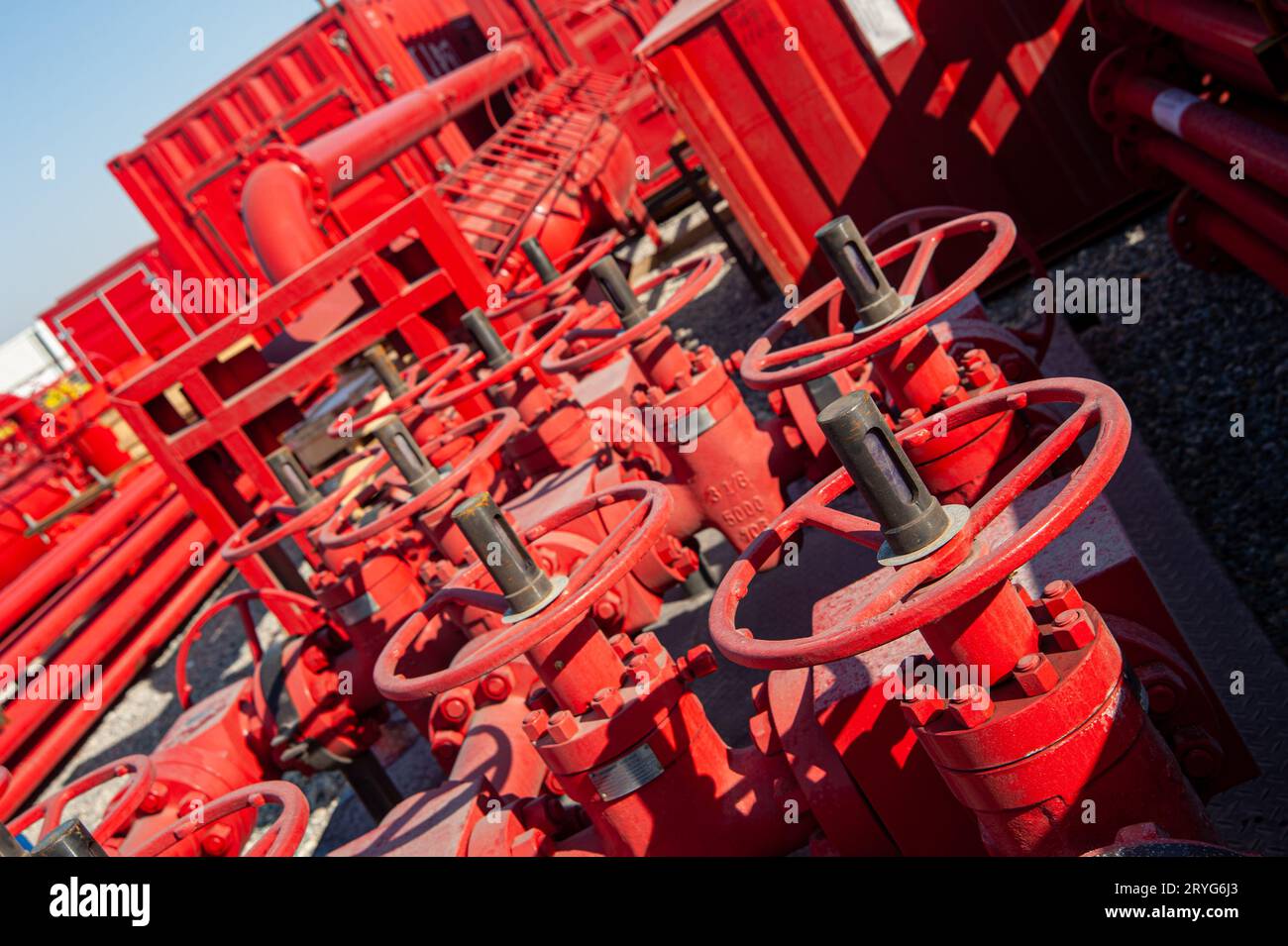 A closeup of a red industrial oil pipeline valves Stock Photo - Alamy