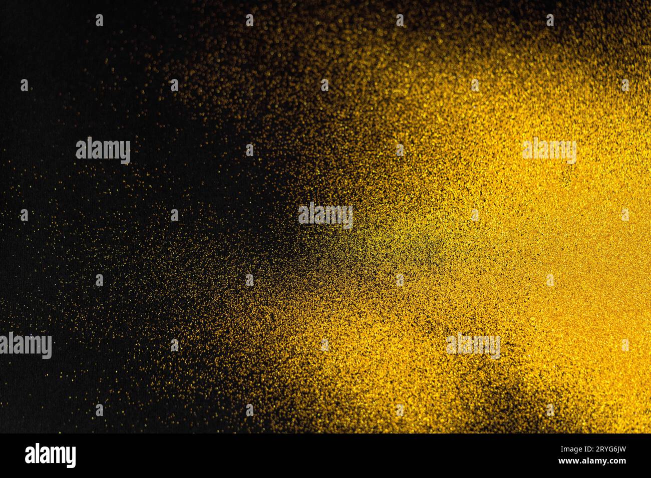 A minimal golden sand texture on a black background Stock Photo - Alamy
