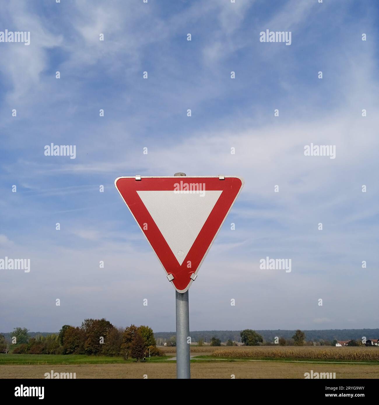 a give way or yield traffic sign on the street Stock Photo - Alamy