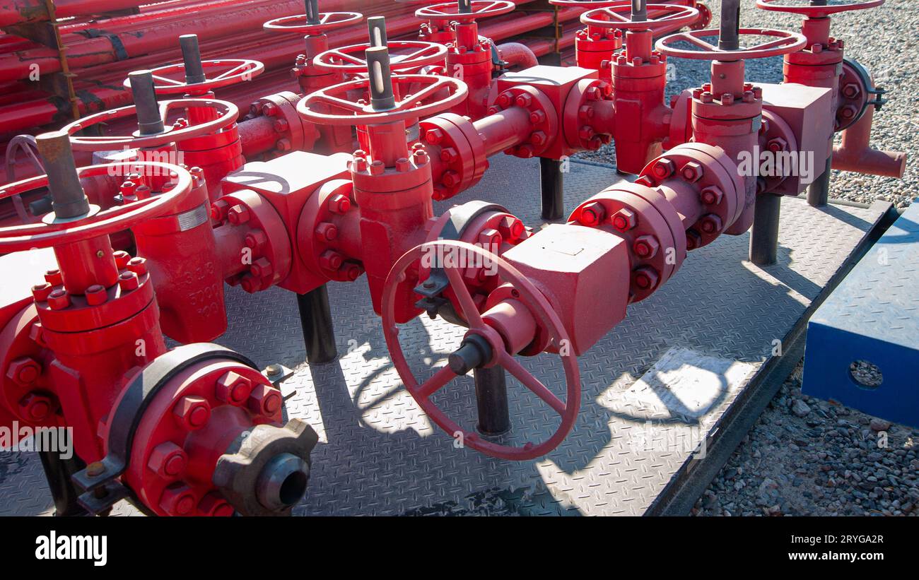 A closeup of a red industrial oil pipeline valves Stock Photo - Alamy