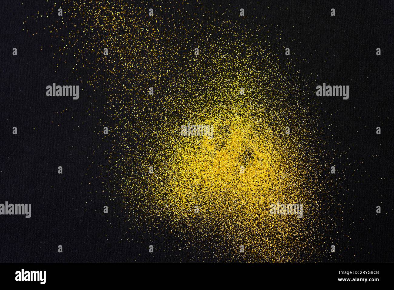 A minimal golden sand texture on a black background Stock Photo - Alamy