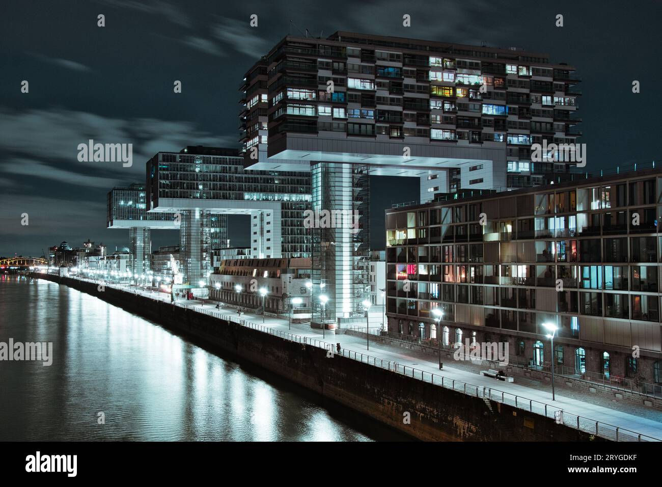 Aerial view of illuminated crane houses by the canal at the Zollhafen ...