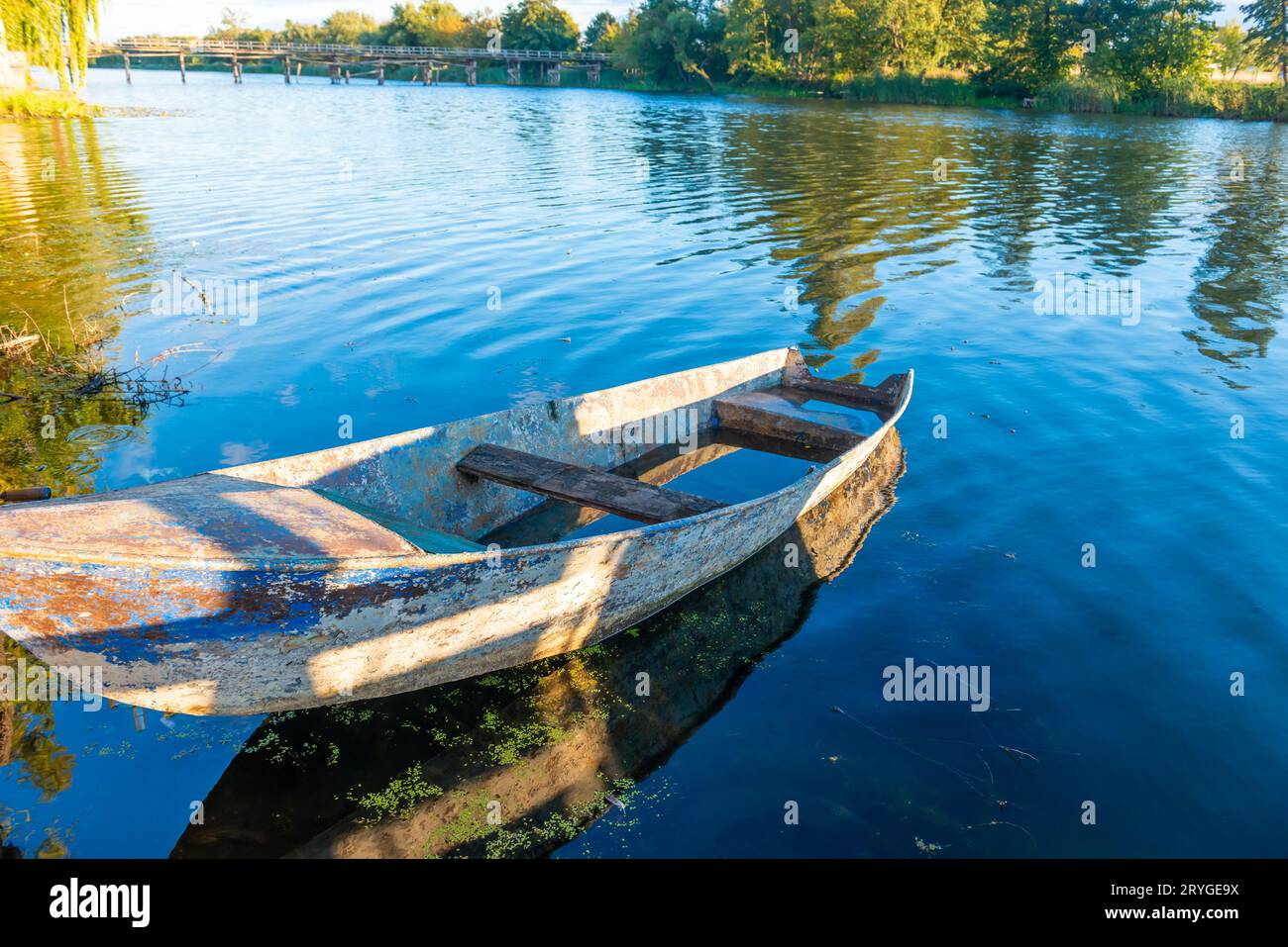 Wooden old fishing boat on river Stock Photo - Alamy