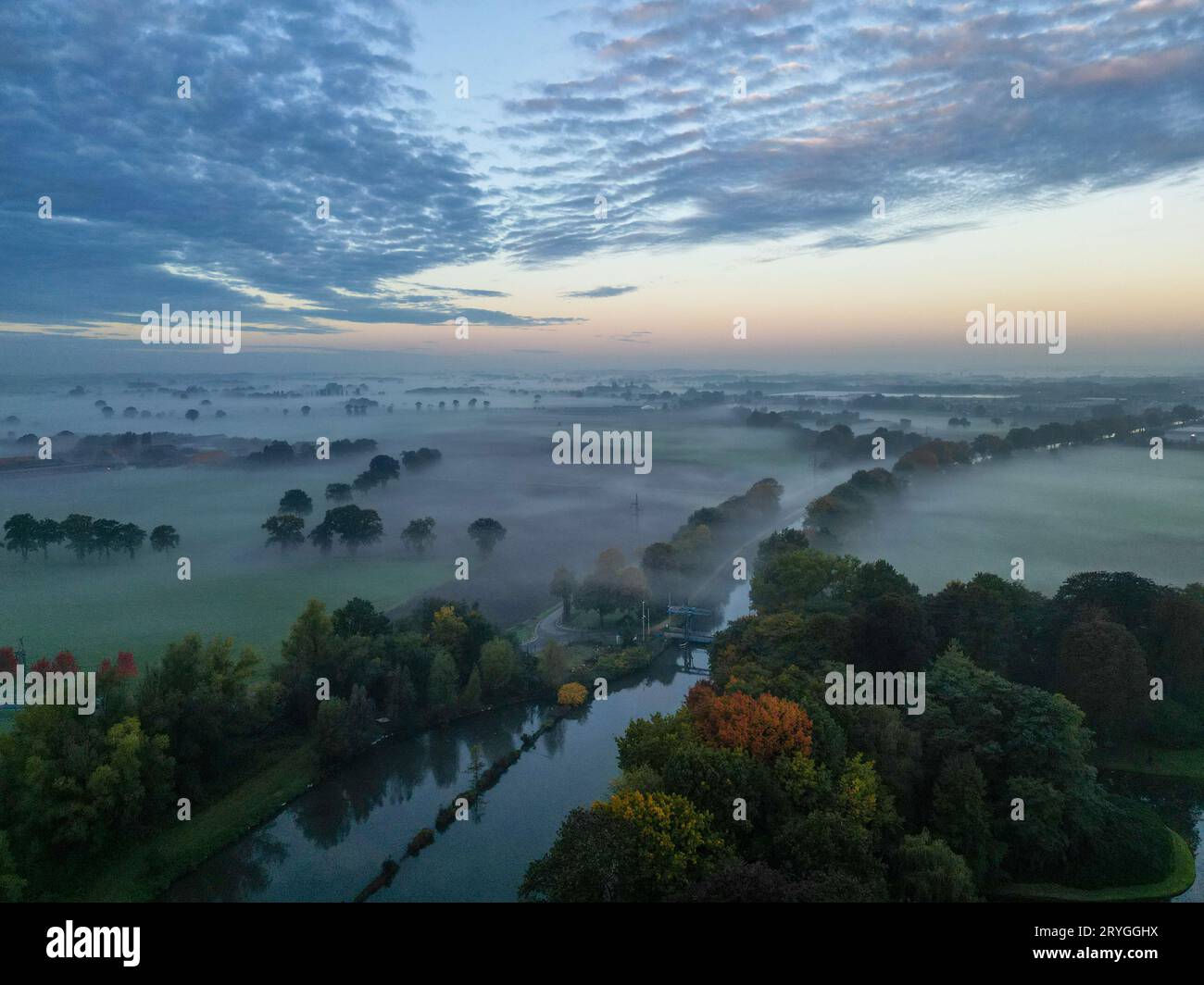 Aerial view of a rural landscape during sunrise in Belgium. Rural farm ...