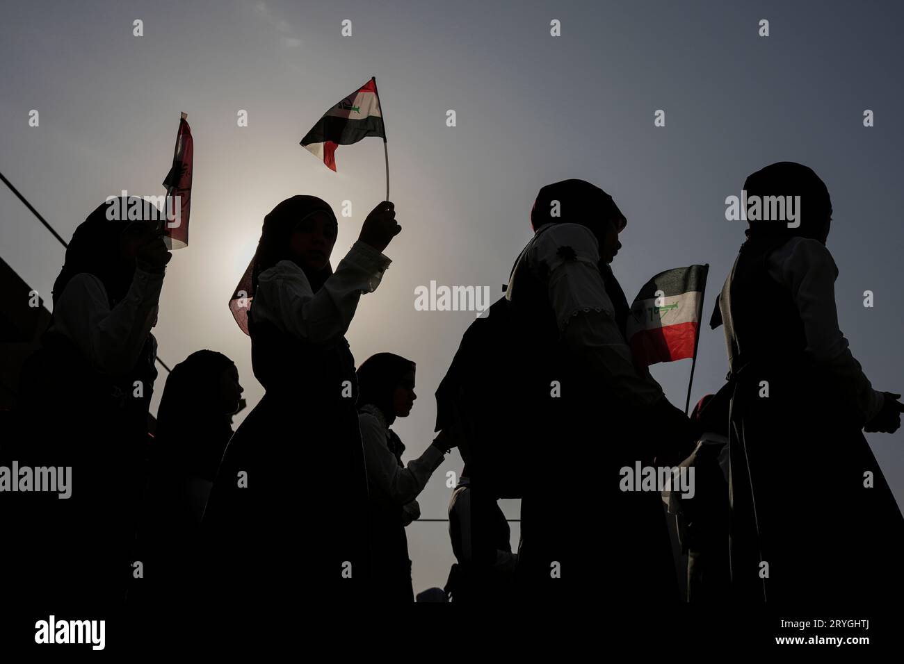 Students prepare to enter a classroom in their new uniforms on the ...