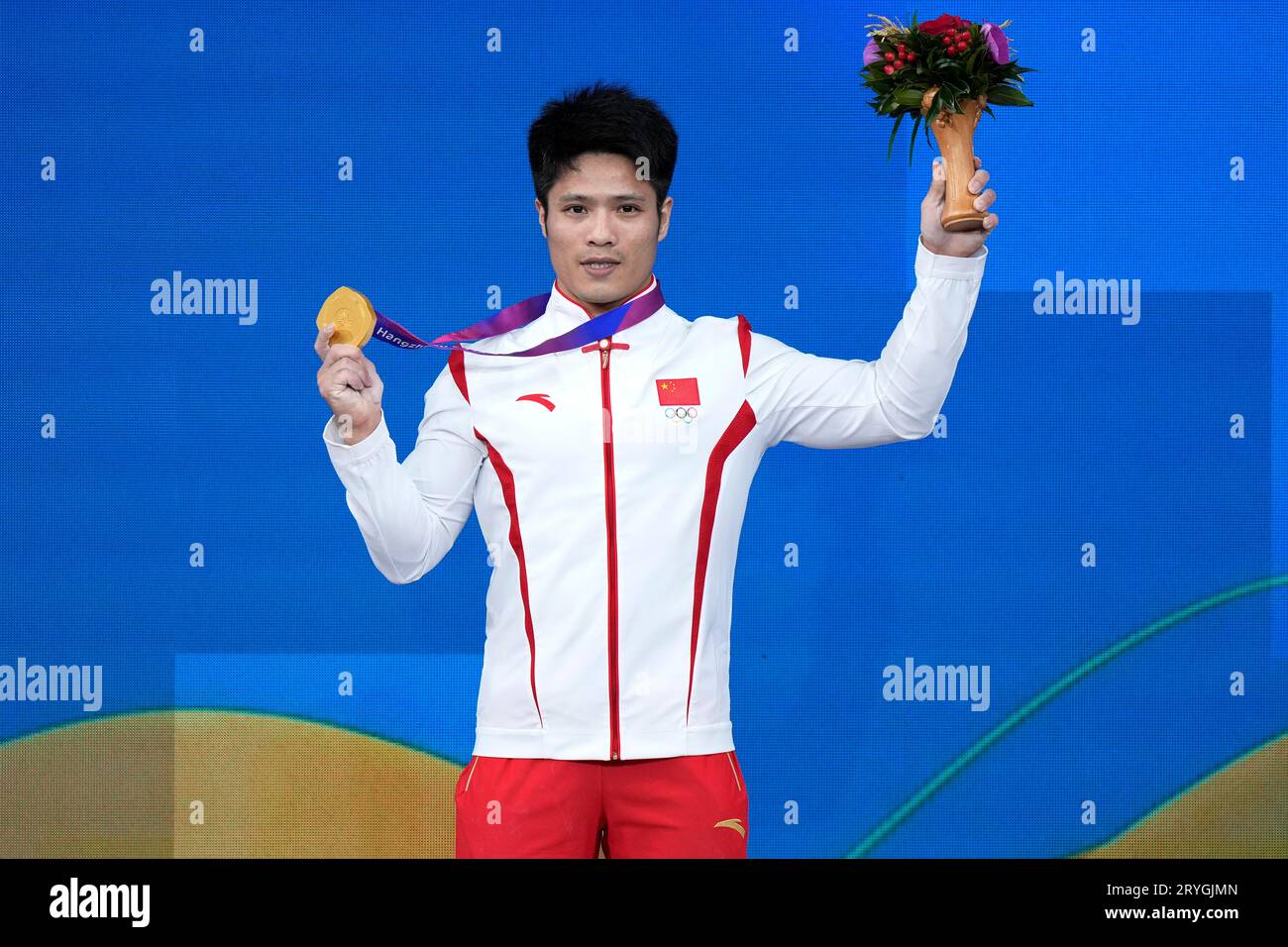 Gold medalist China's Fabin Li poses on the podium during the awards ...