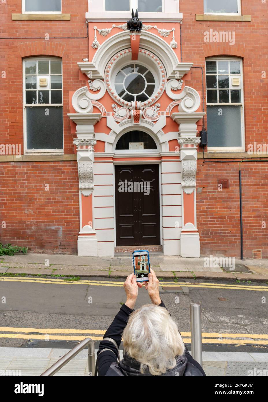 A visitor takes a photo of the Vampire Rabbit behind the Cathedral of ...