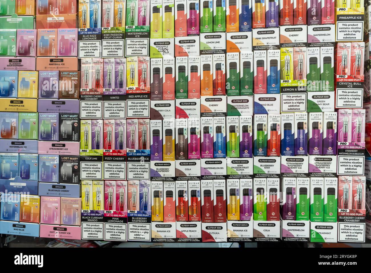Brightly coloured and flavoured vapes packaging on display in a shop ...