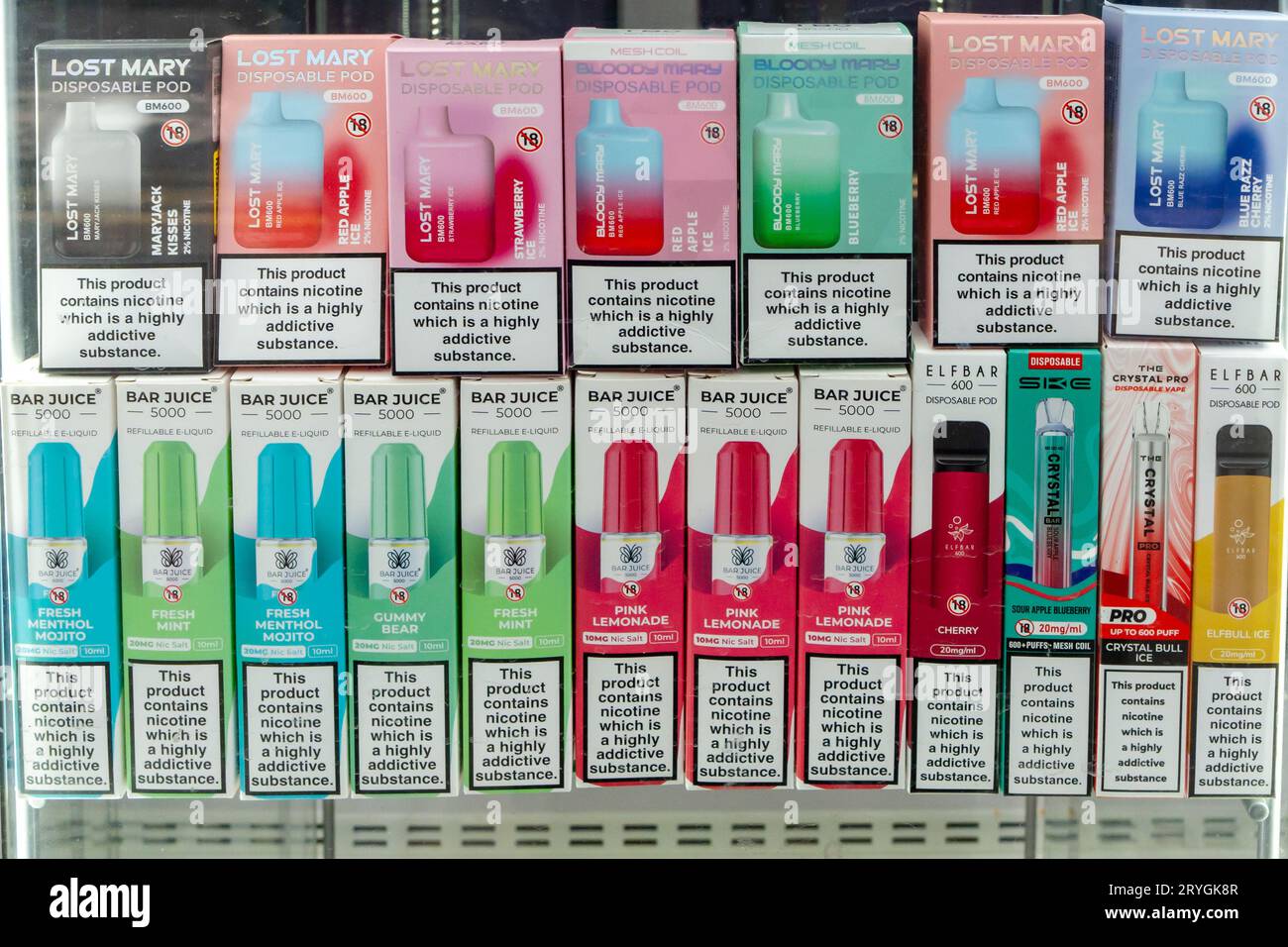 Brightly coloured and flavoured vapes packaging on display in a shop ...