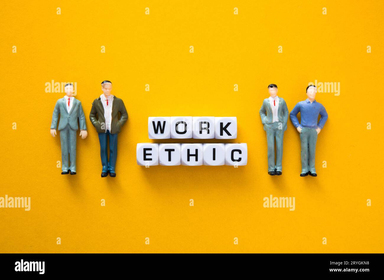 Miniature figure with Work ethic words on yellow background. Ethics ...