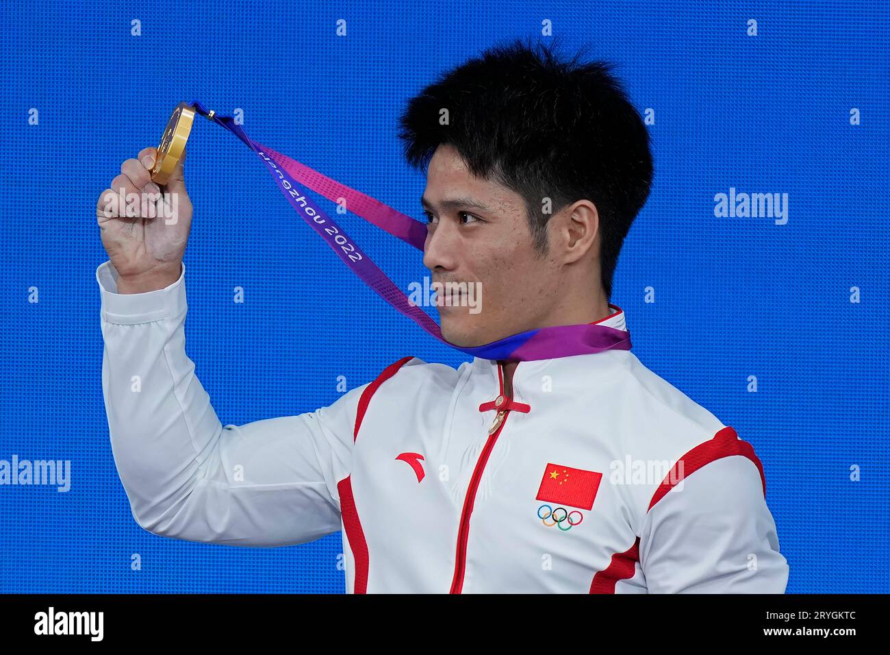 Gold medalist China's Fabin Li poses on the podium during the awards ...