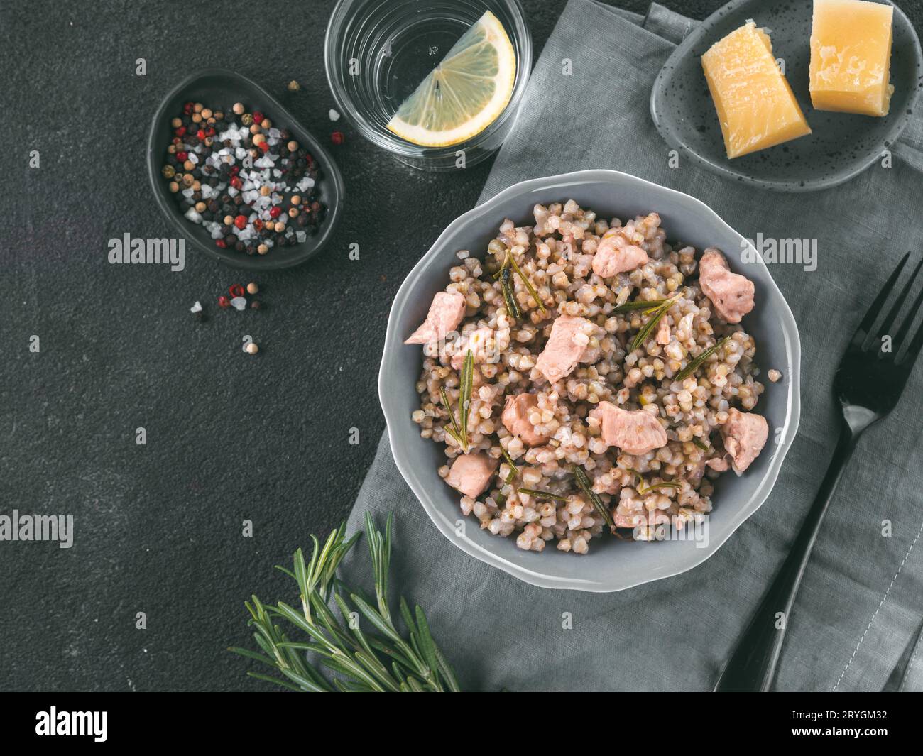 Raw buckwheat risotto with chicken meat and rosemary Stock Photo - Alamy