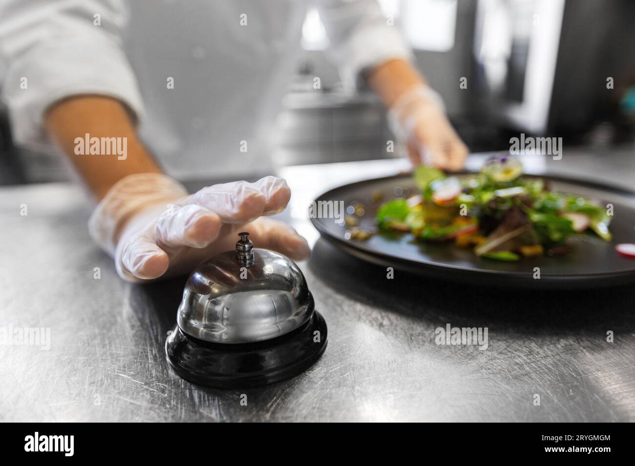 close up of chef ringing bell at restaurant Stock Photo - Alamy