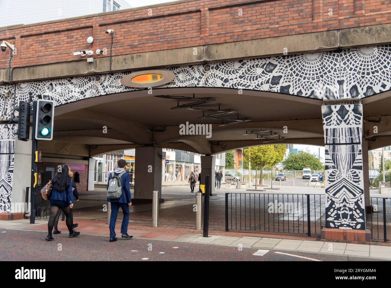 People cross under the railway bridge to go, 'over the border' in the ...