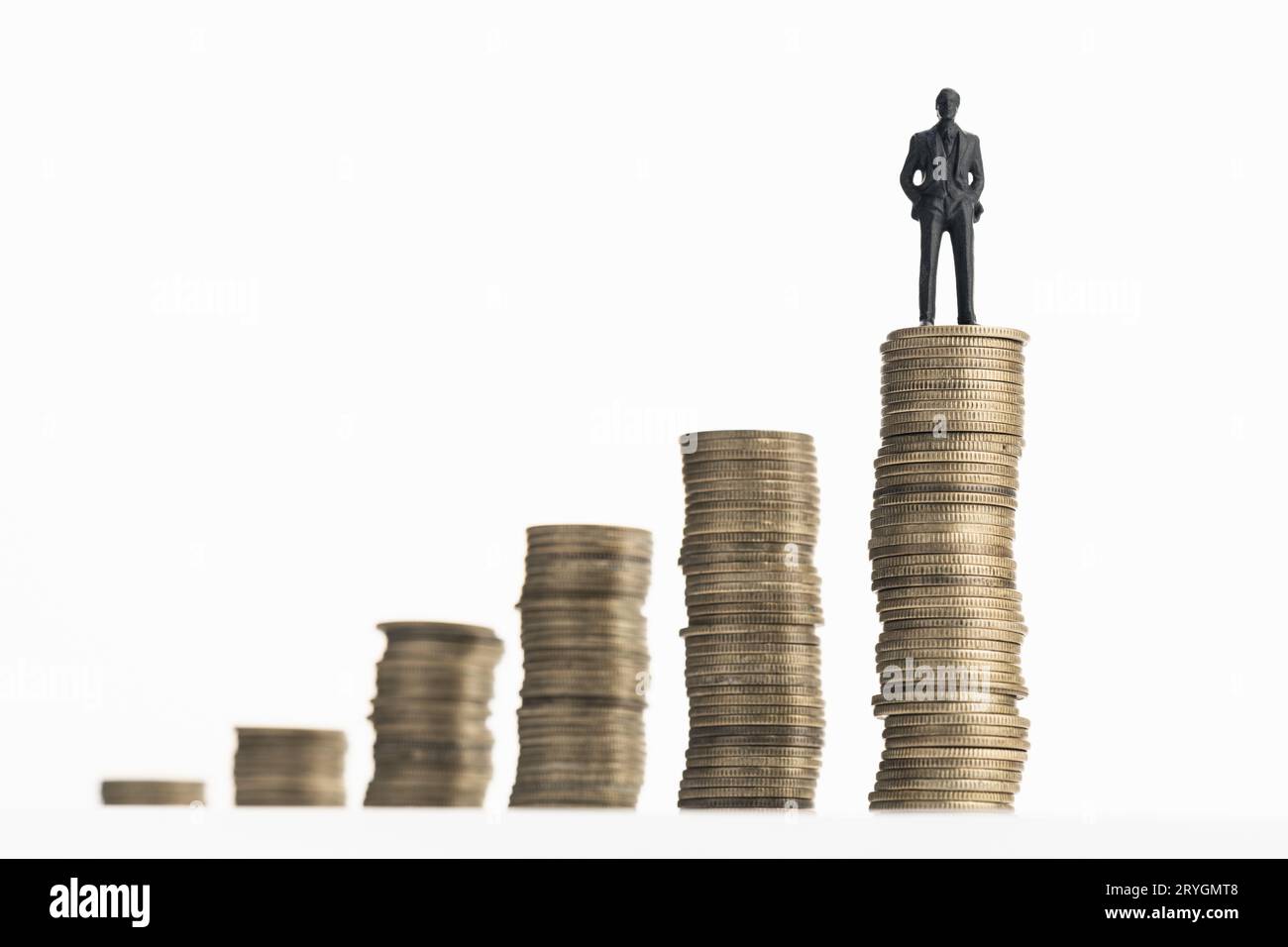 Figurine on stack coins hi-res stock photography and images - Alamy