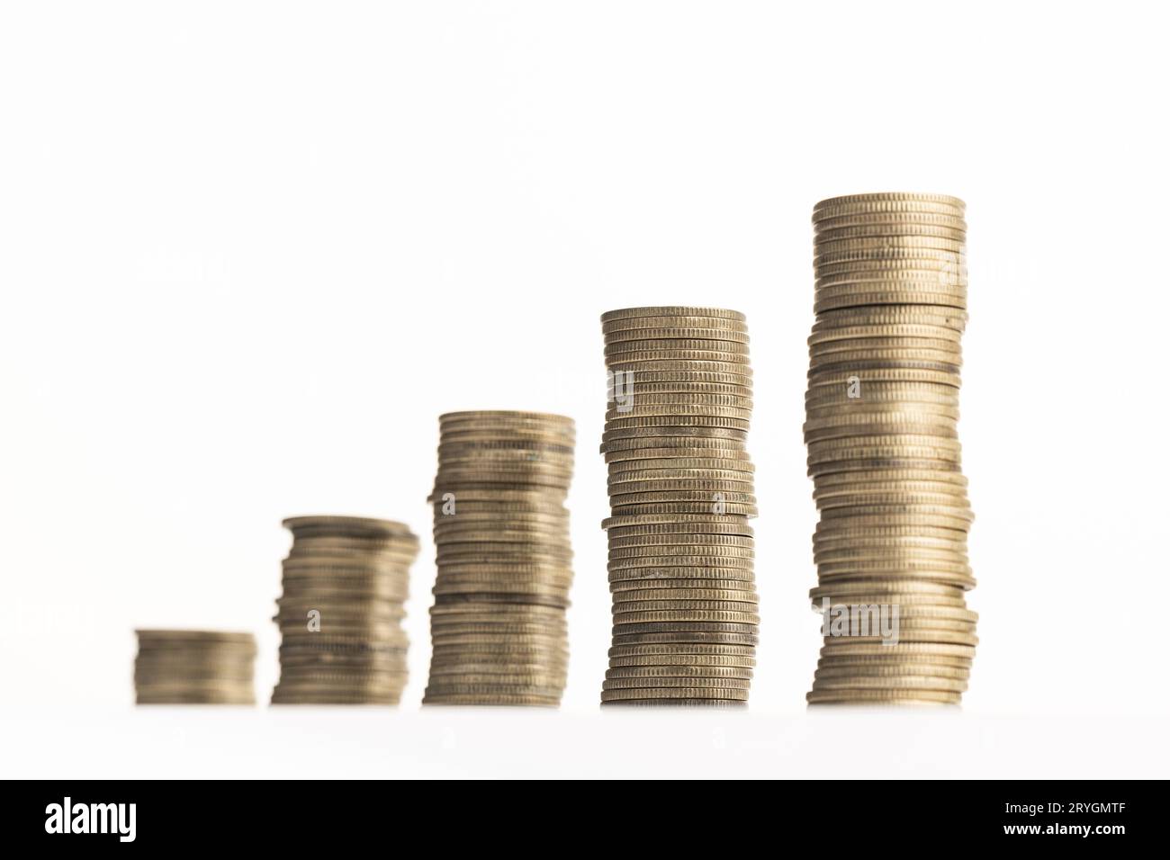 Rising stack of coins isolated on a white background Stock Photo - Alamy
