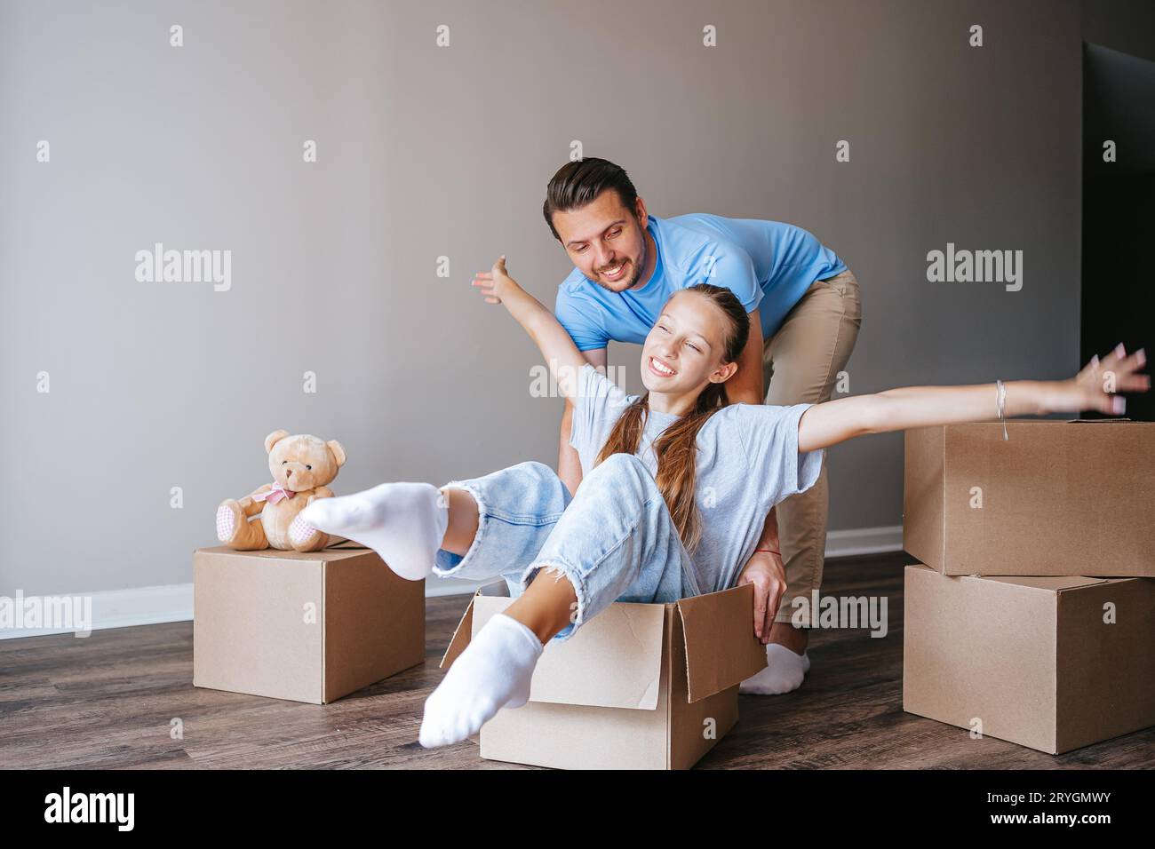 Family of father and adorable teen daughter have fun on moving day in ...