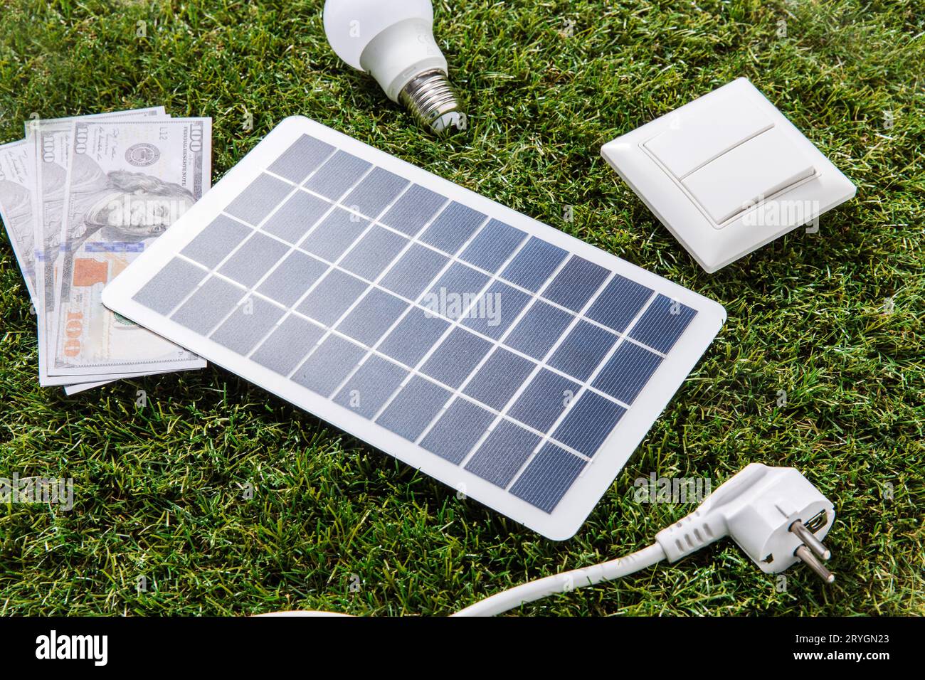 solar battery, bulb, money, bills and calculator Stock Photo - Alamy
