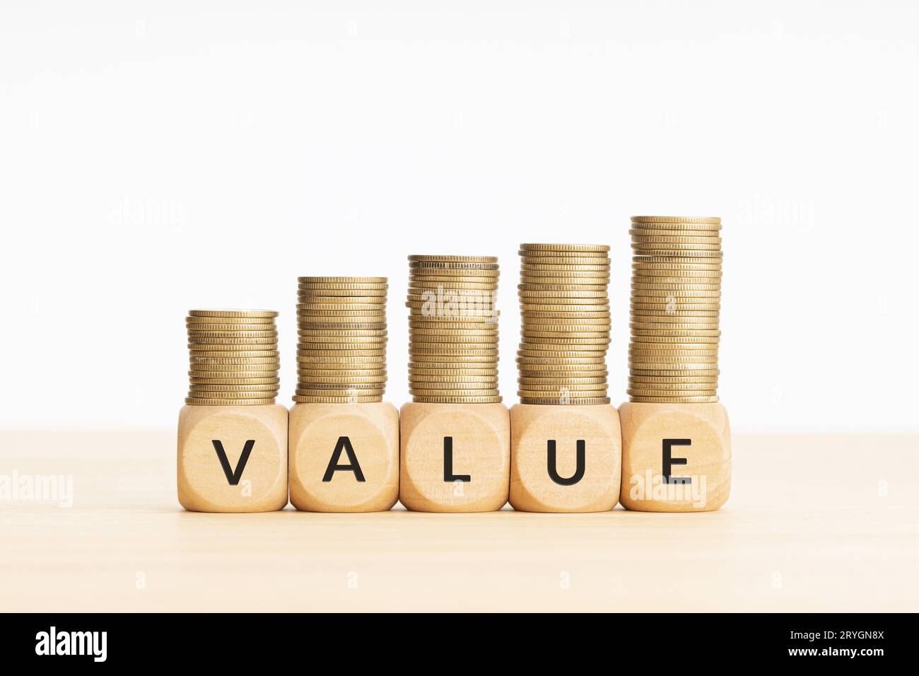 Value word on wooden blocks and rising stacked coins Stock Photo - Alamy