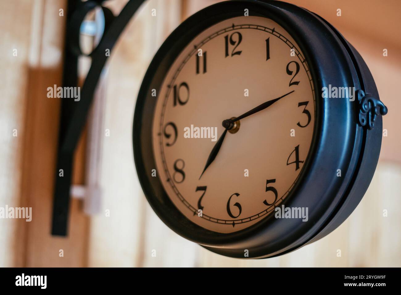 Decorative elements. Round vintage clock in black metal hanging on ...