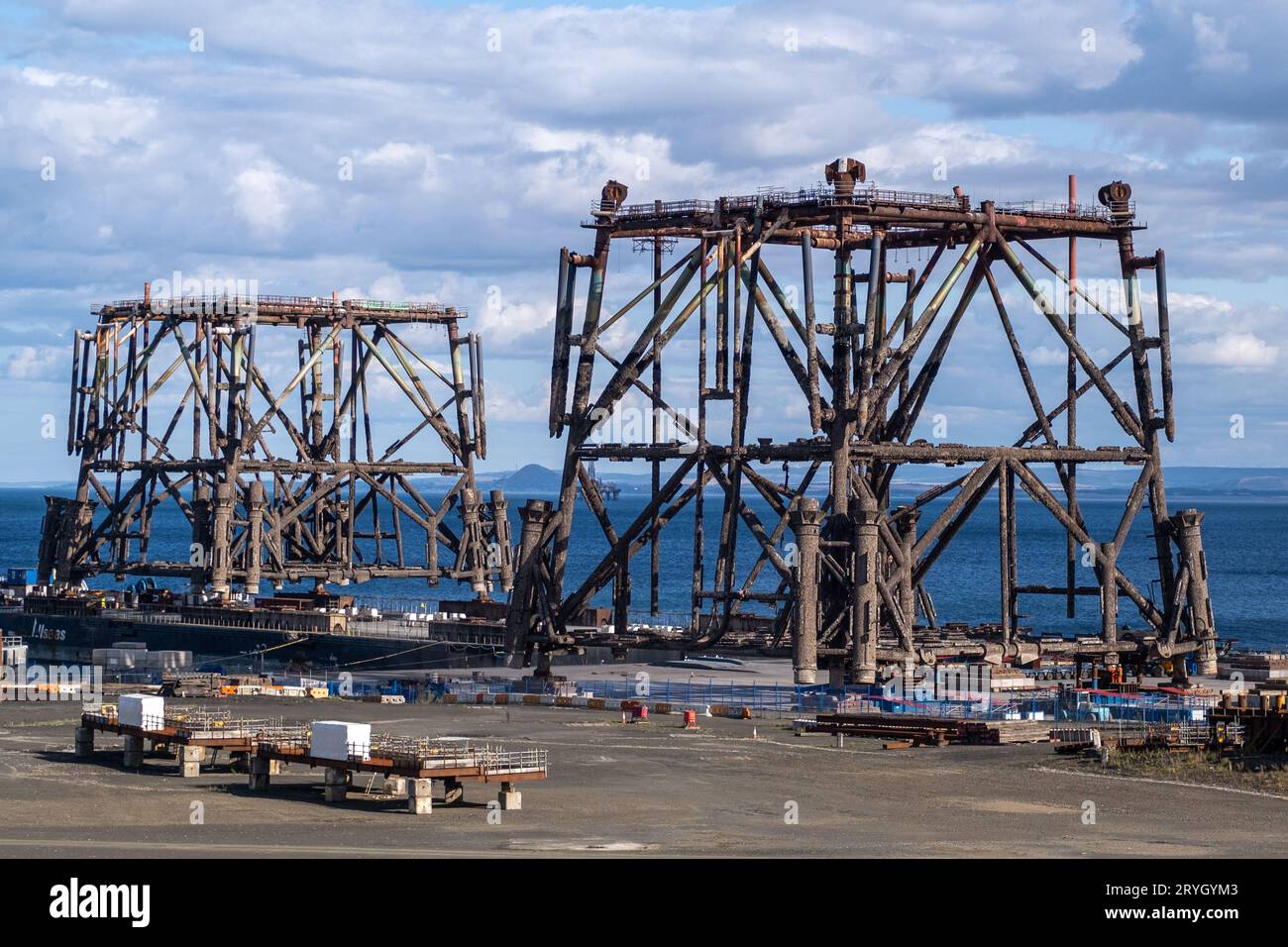 Two large oil rig structures being decommissioned at a ship yard ...