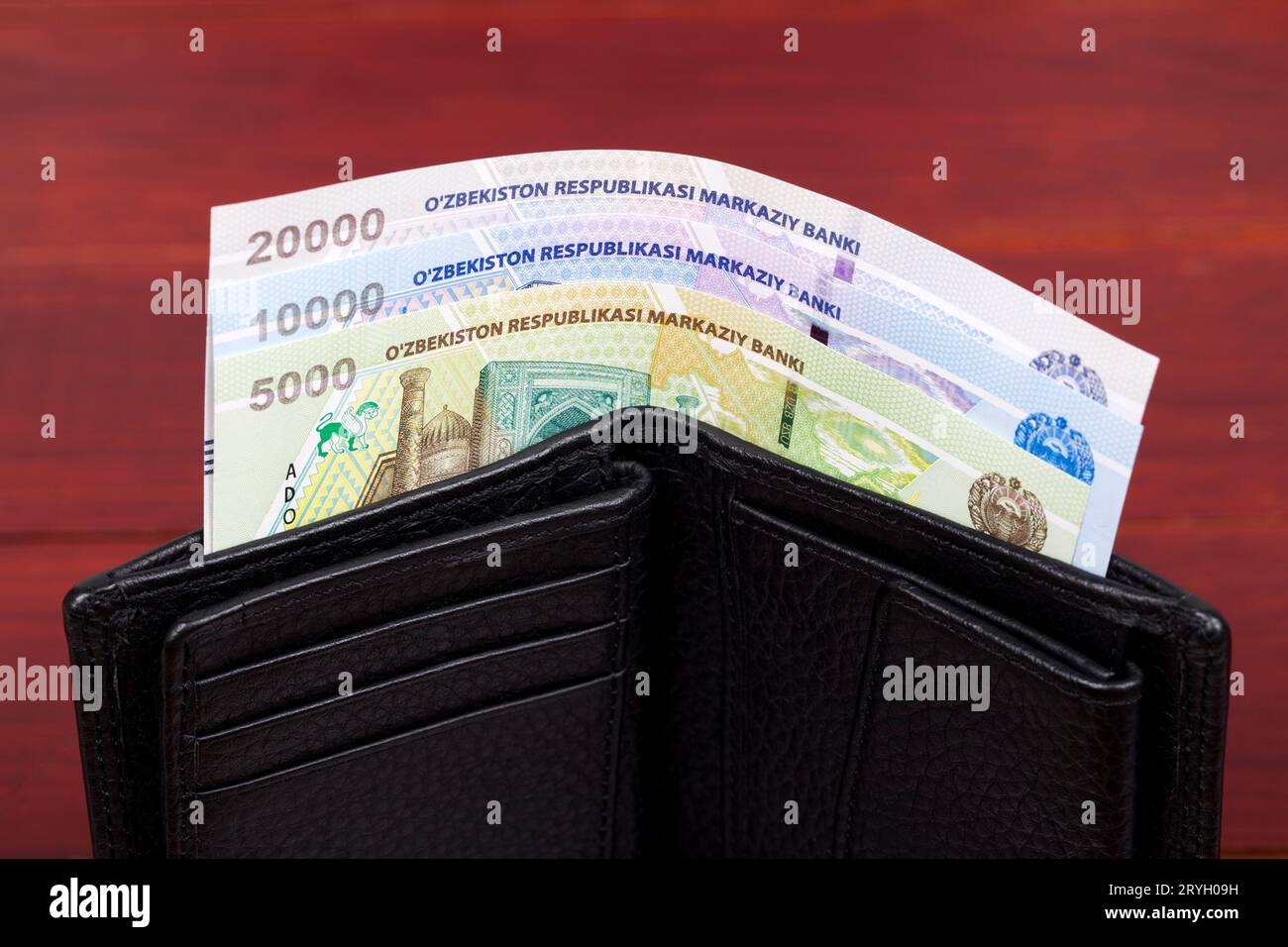 Uzbekistani money - som in the black wallet Stock Photo - Alamy