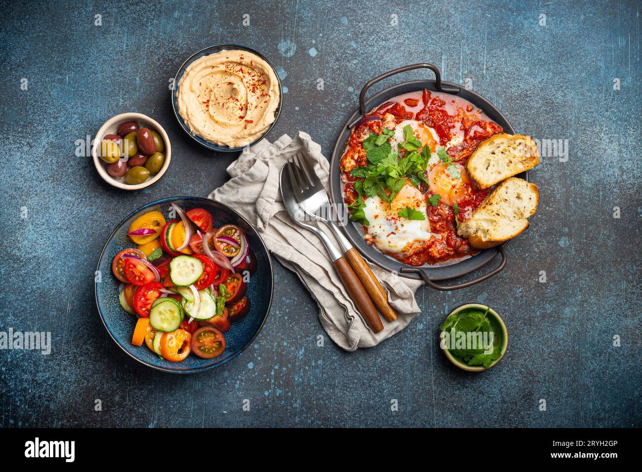 Middle Eastern breakfast or brunch with Shakshouka in pan, toasts ...