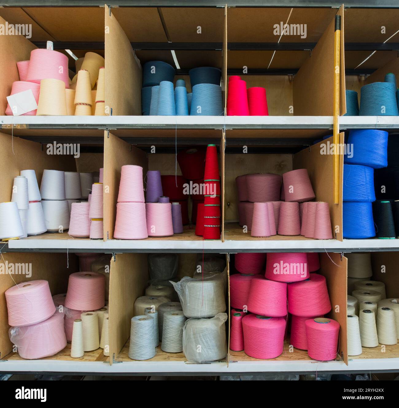 Spools with color thread at knitting factory view Stock Photo - Alamy