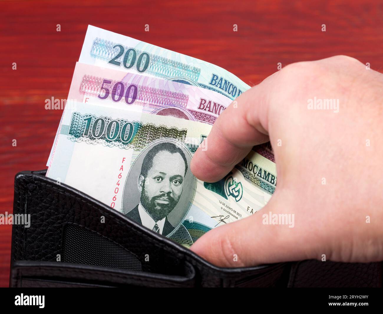 Mozambican money - metical in the black wallet Stock Photo - Alamy