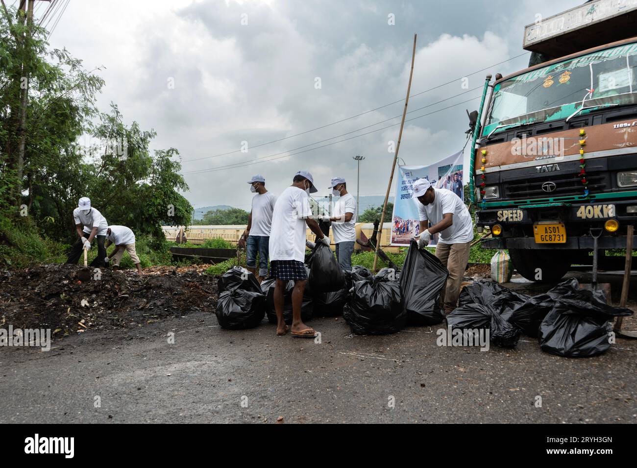 Volunteers of Indian Oil Corporation cleans garbage near a road as they ...