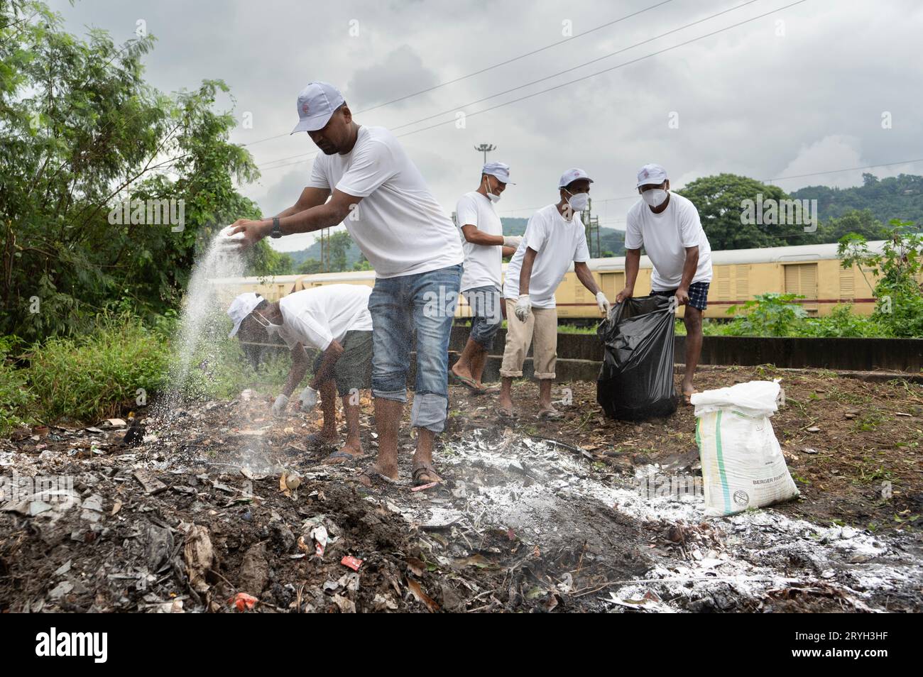 Volunteers of Indian Oil Corporation scatters bleaching powder after ...