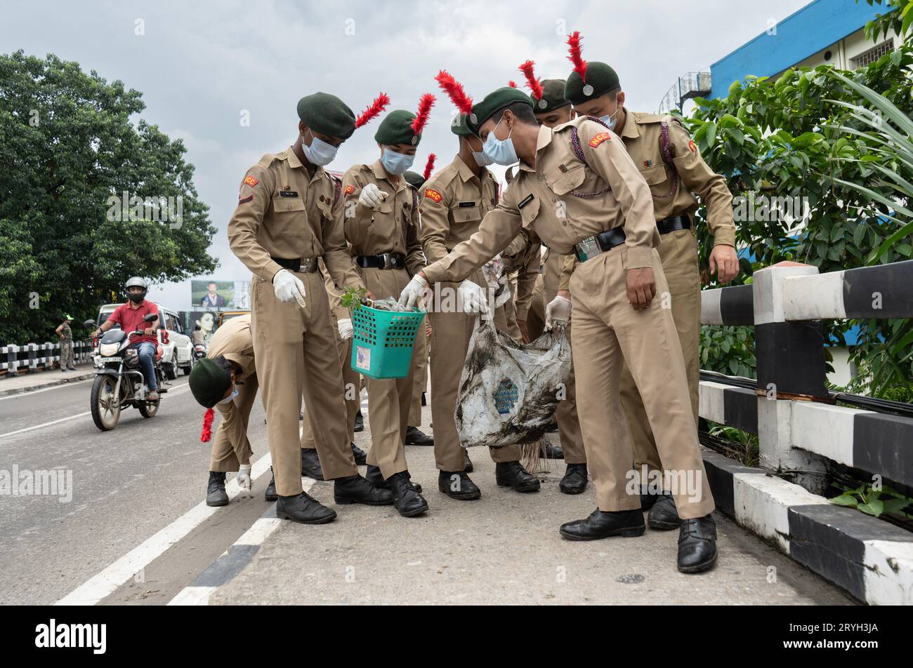 National Cadet Corps (NCC) personnel cleans garbage near a road as they ...