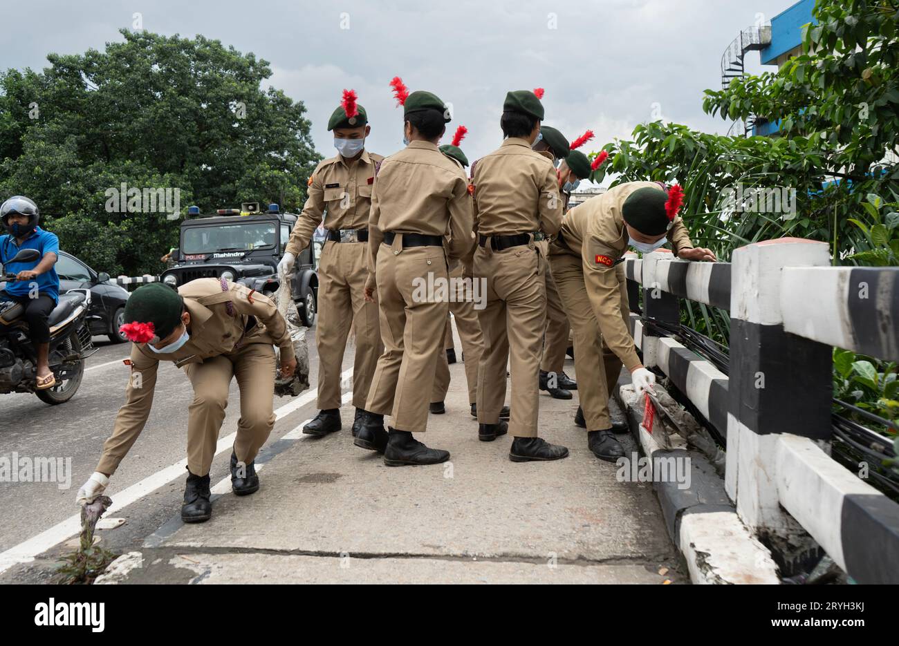 National Cadet Corps (NCC) personnel cleans garbage near a road as they ...