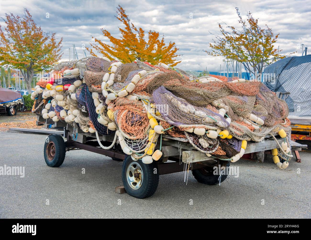 Trawler fishing net and floats stored on auto trailer Stock Photo - Alamy
