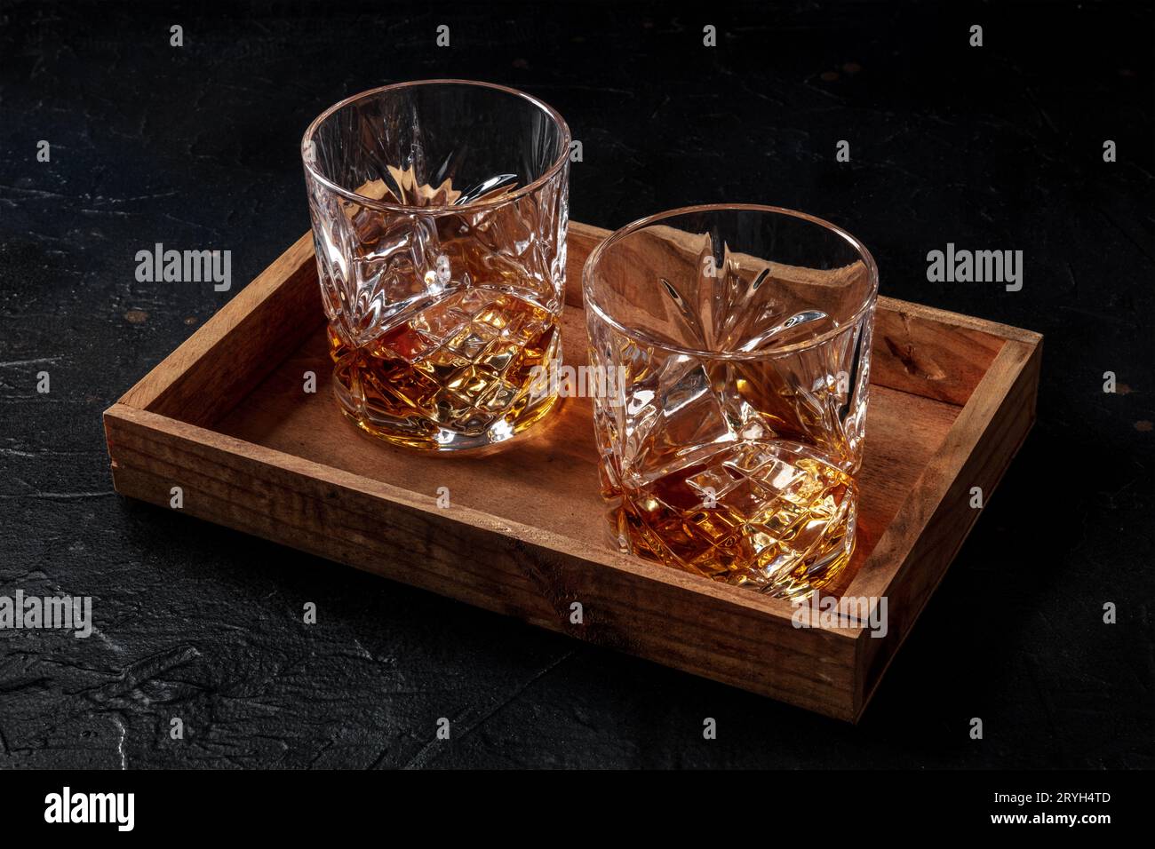 Whiskey in glasses with ice. Bourbon whisky on rocks on a dark ...