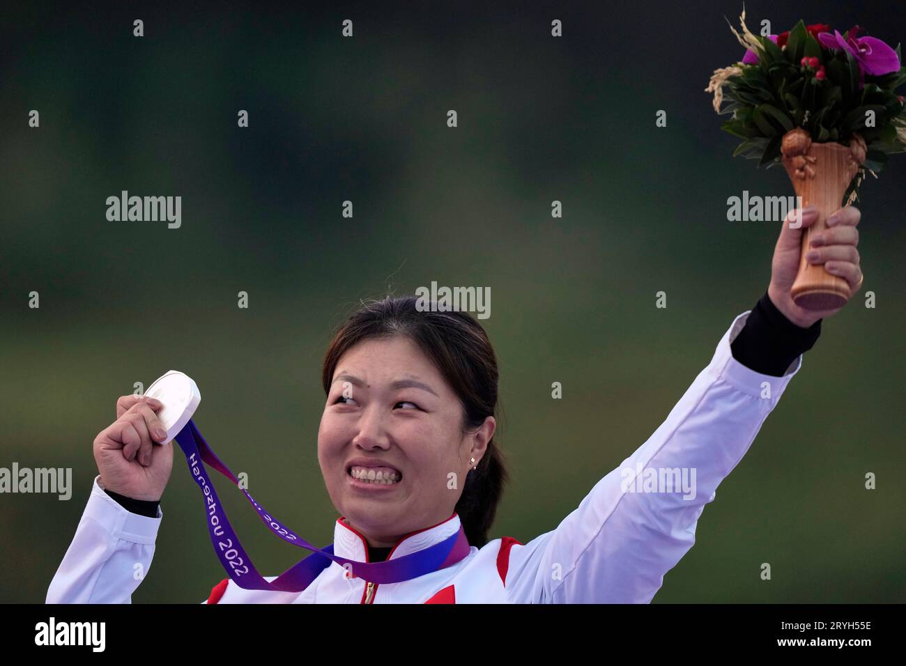 China's Wu Cuicui celebrates with her silver medal on the podium during ...