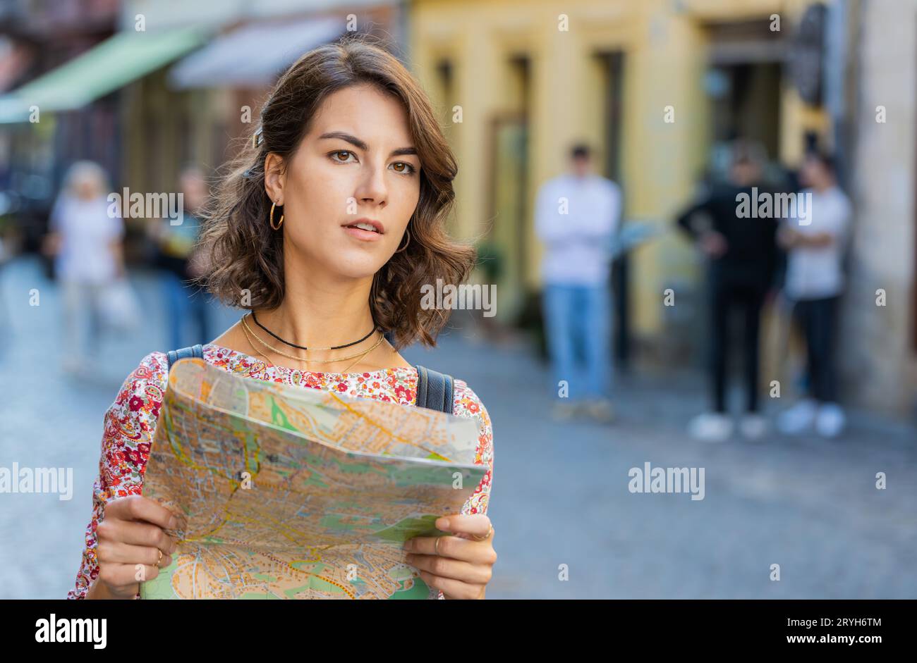 Caucasian confused woman lost while traveling in Europe city, exploring sightseeing, navigating ...