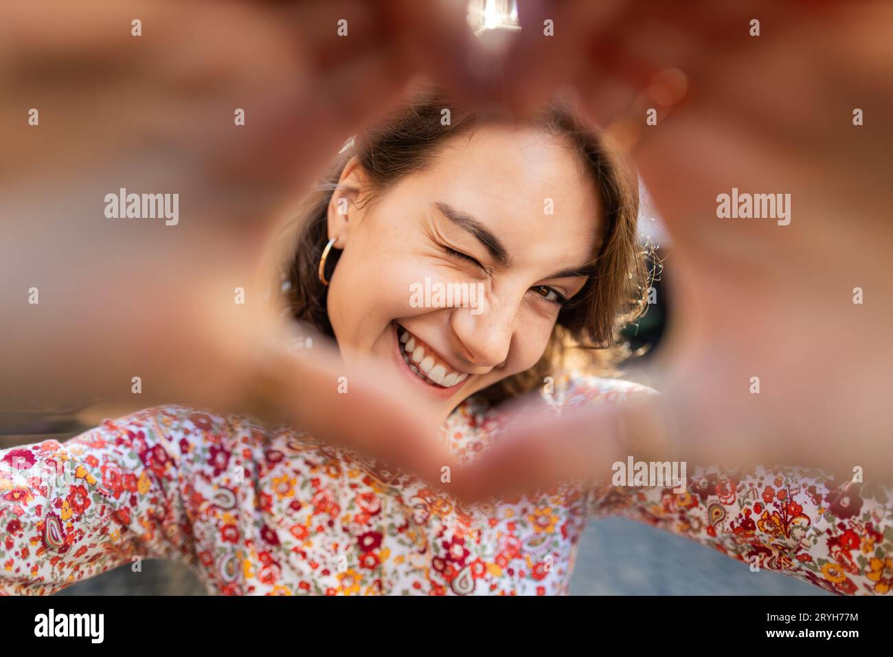 I love you. Portrait of Caucasian woman makes symbol of love, showing ...